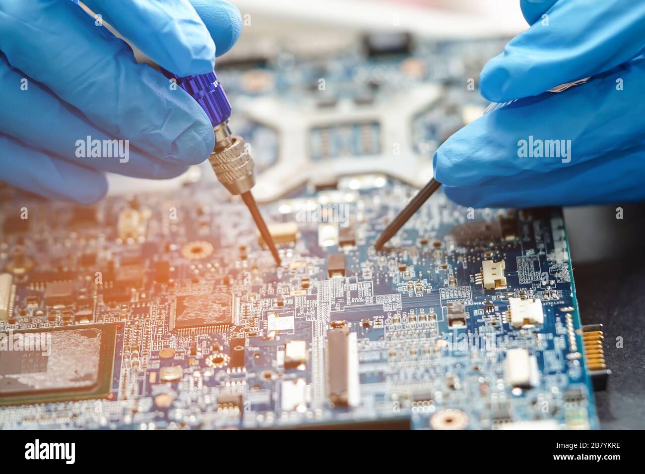 Technician repairing micro circuit main board computer electronic ...