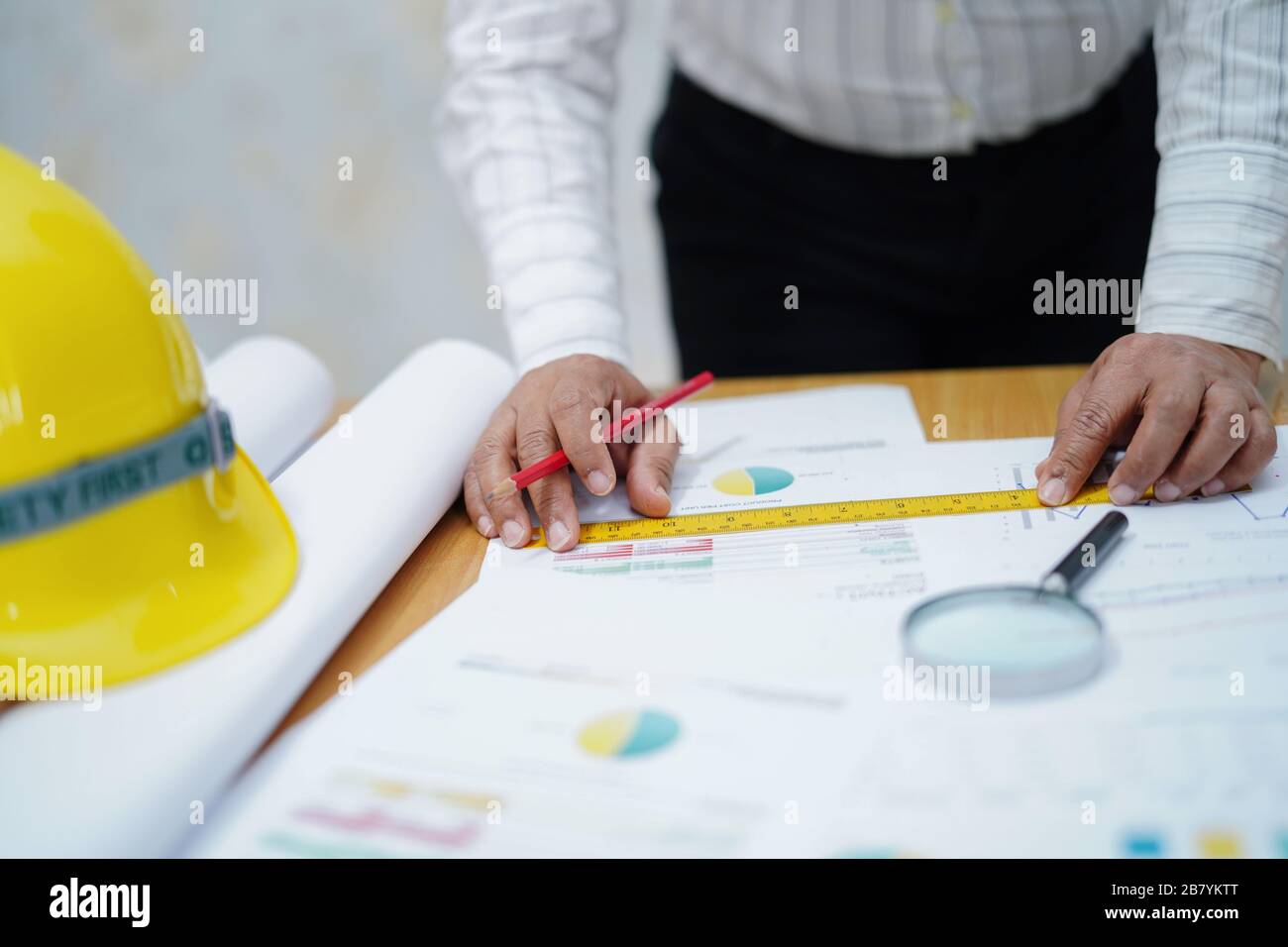 Architect or engineer working project accounting with graph with tools ...
