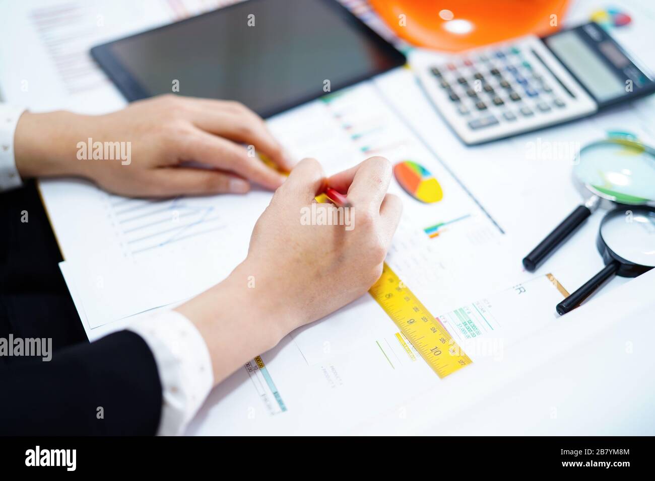 Architect or engineer working project accounting with graph with tools ...