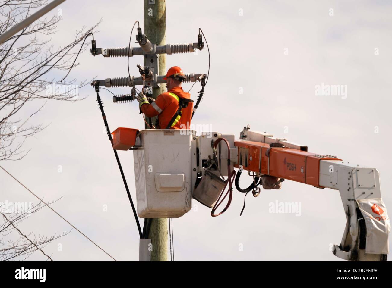 Hydro linesman working on hydro lines Stock Photo - Alamy