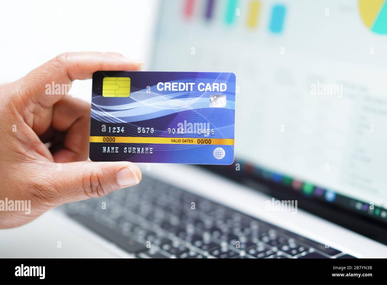 Asian accountant holding credit card and working, calculate, analyzing ...