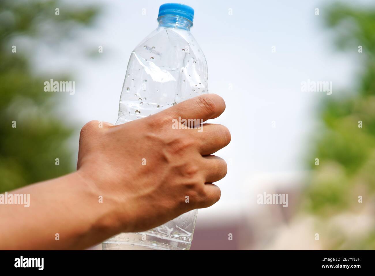 Hand squeeze empty water bottle prepare throw into the trash Stock ...