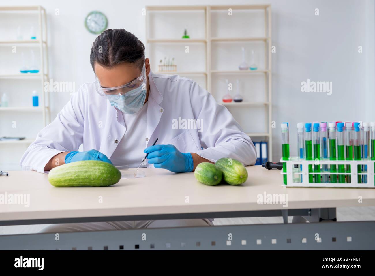 The male nutrition expert testing vegetables in lab Stock Photo - Alamy