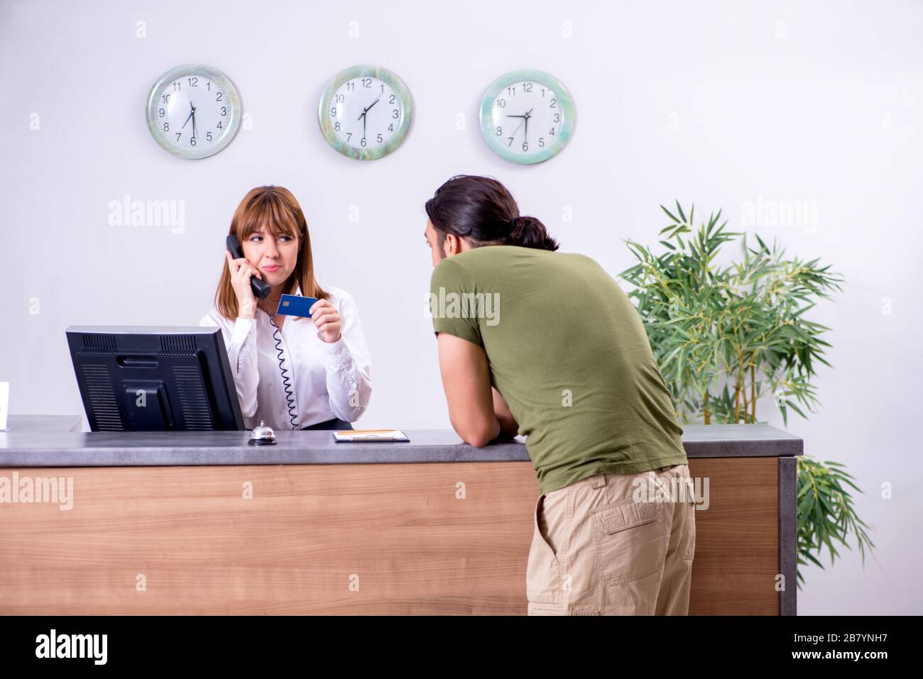 The young man at the hotel reception Stock Photo - Alamy