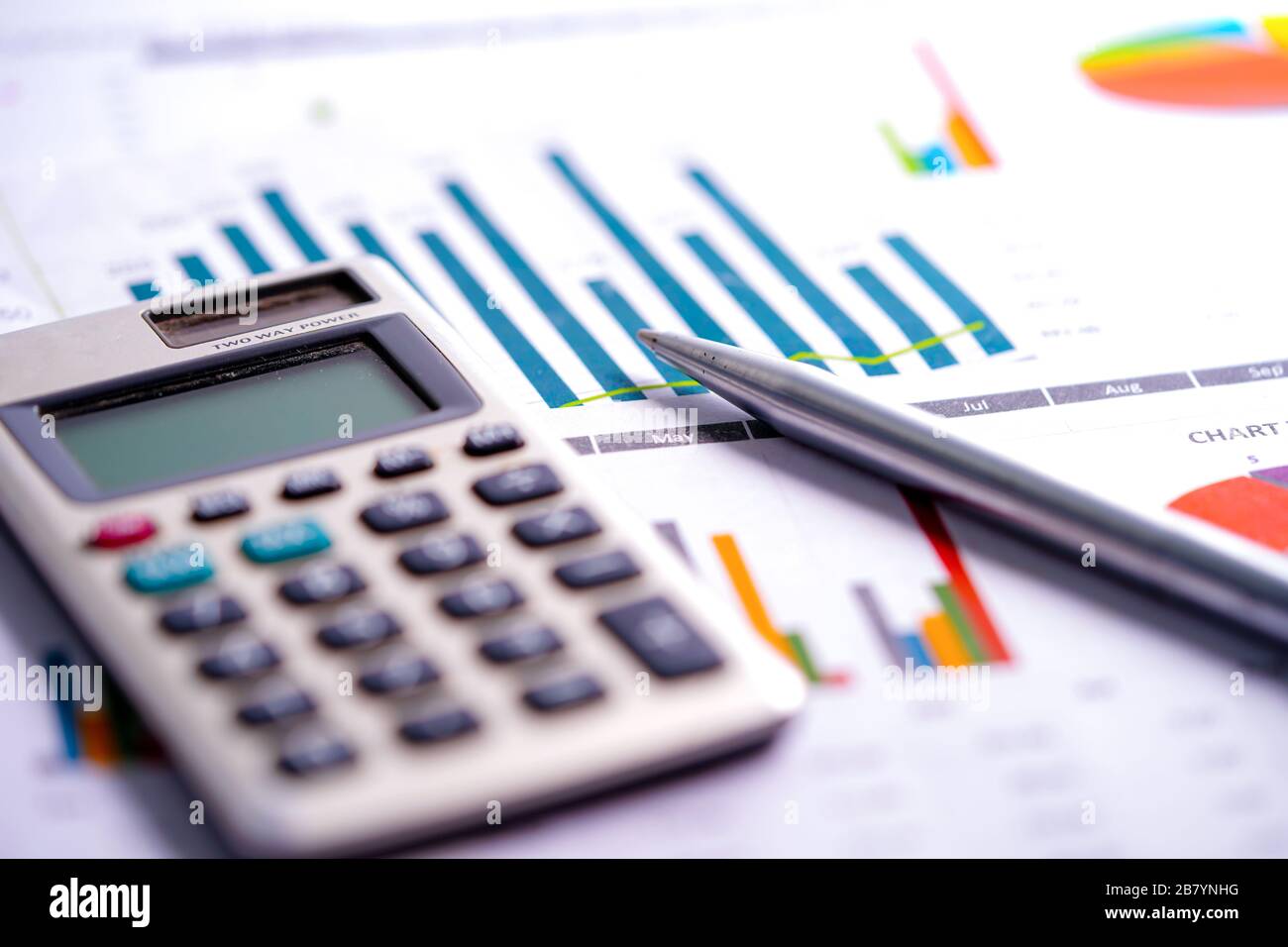 Calculator on chart and graph spreadsheet paper. Finance development ...