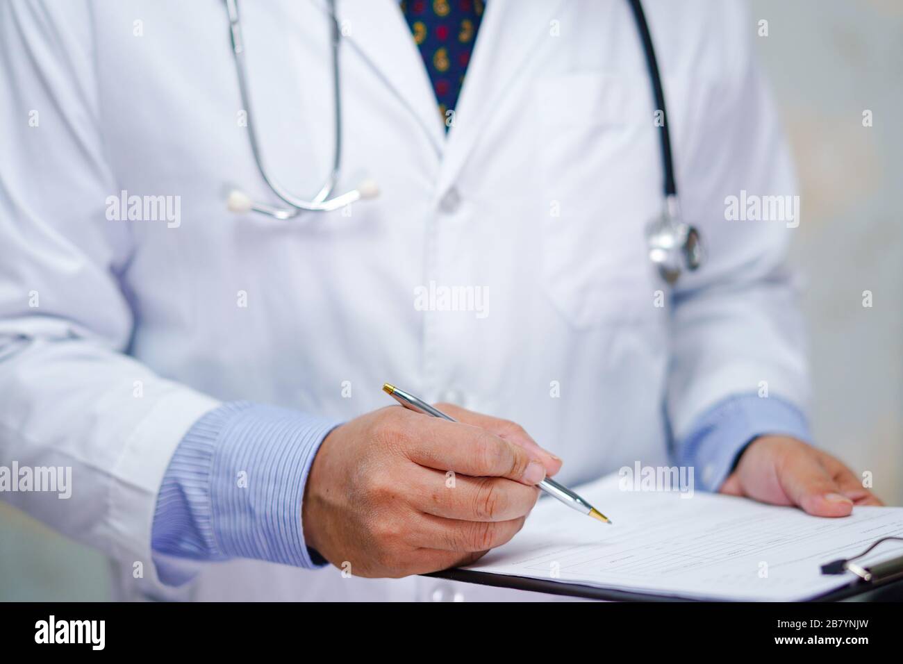 Doctor with stethoscope write into clipboard for note diagnosis of ...