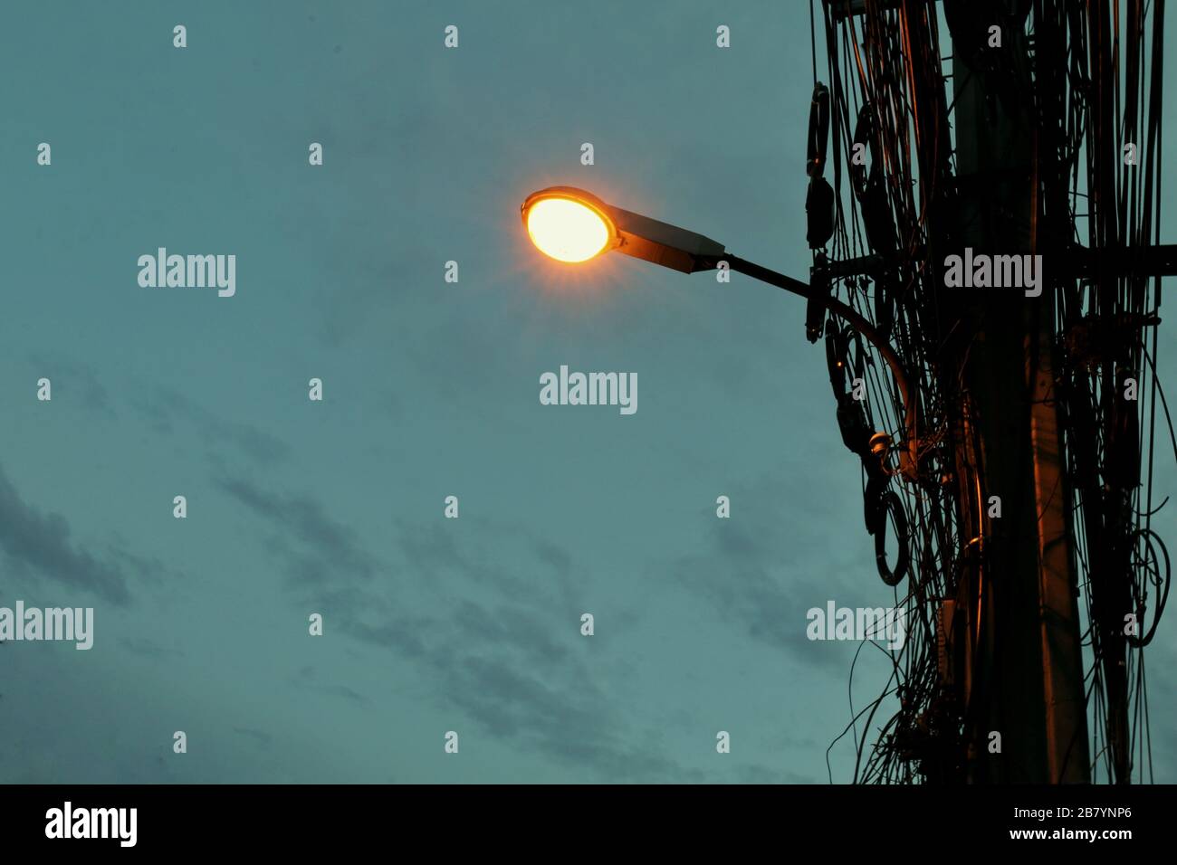 Street lights mounted on poles at evening time Stock Photo - Alamy