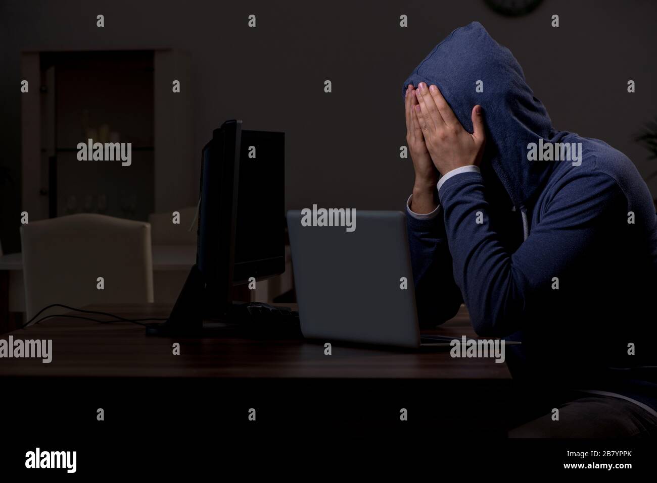 Male hacker hacking security firewall late in the office Stock Photo ...