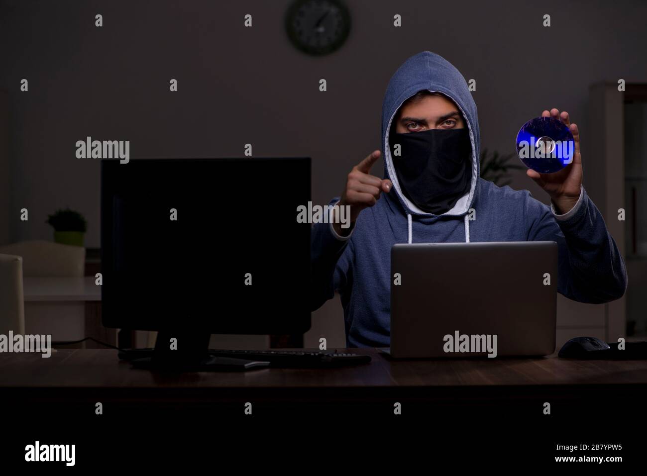Male hacker hacking security firewall late in the office Stock Photo ...