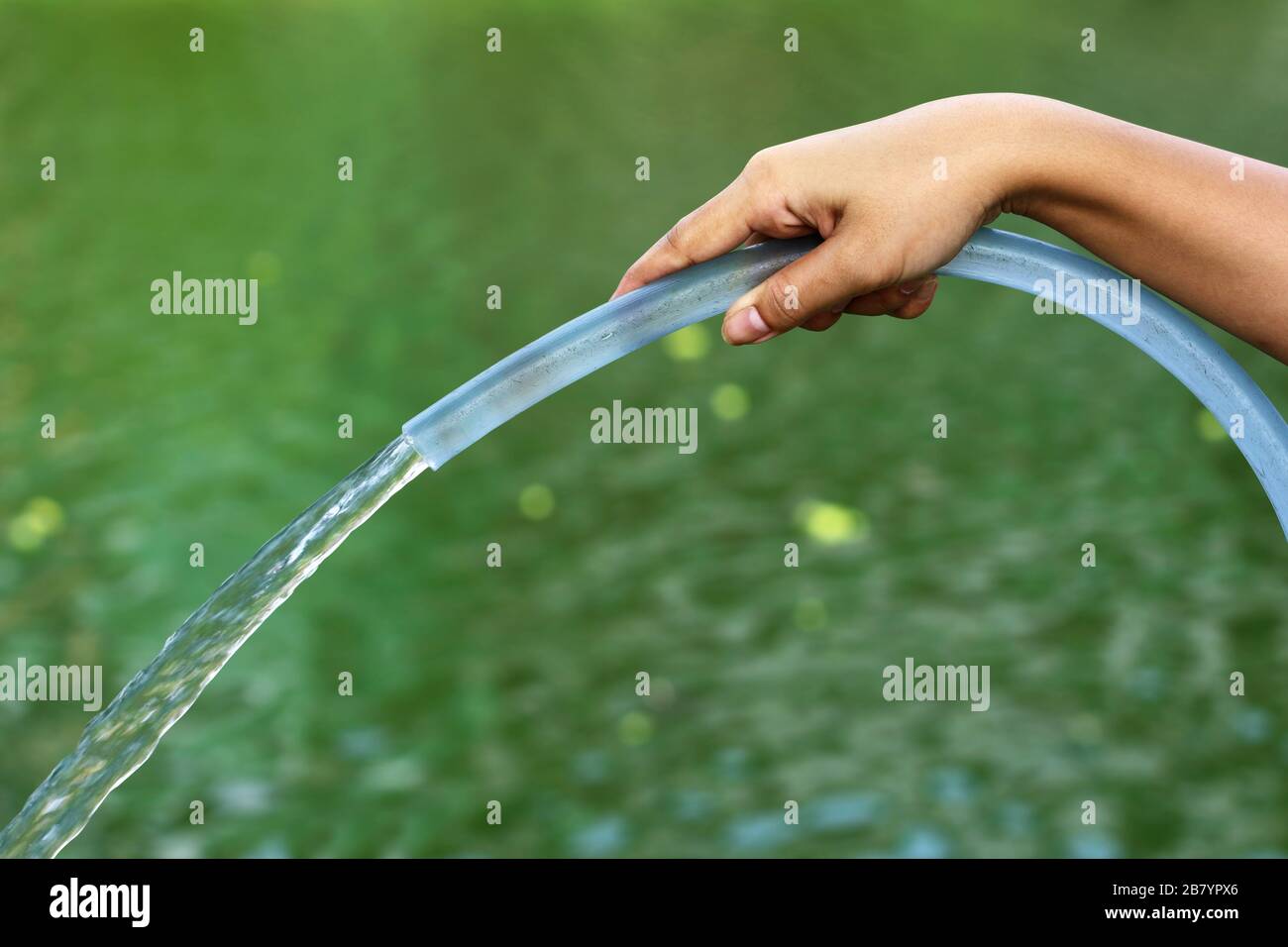 Hand holding hosepipe hi-res stock photography and images - Alamy