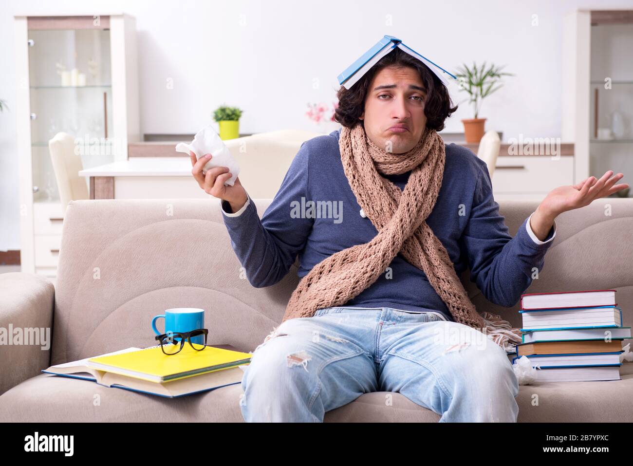 The sick male student suffering at home Stock Photo - Alamy