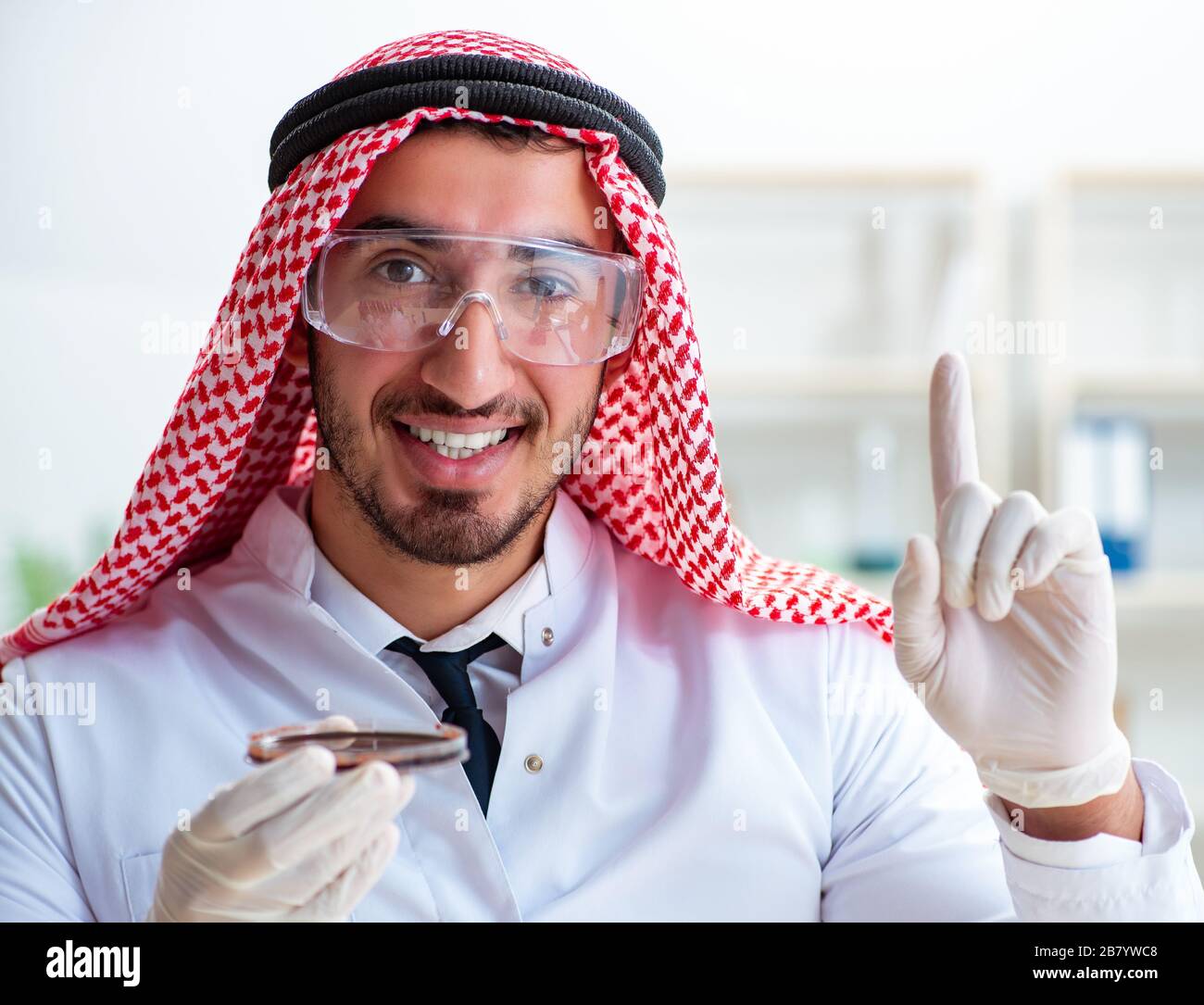 The arab chemist working in the lab office Stock Photo - Alamy