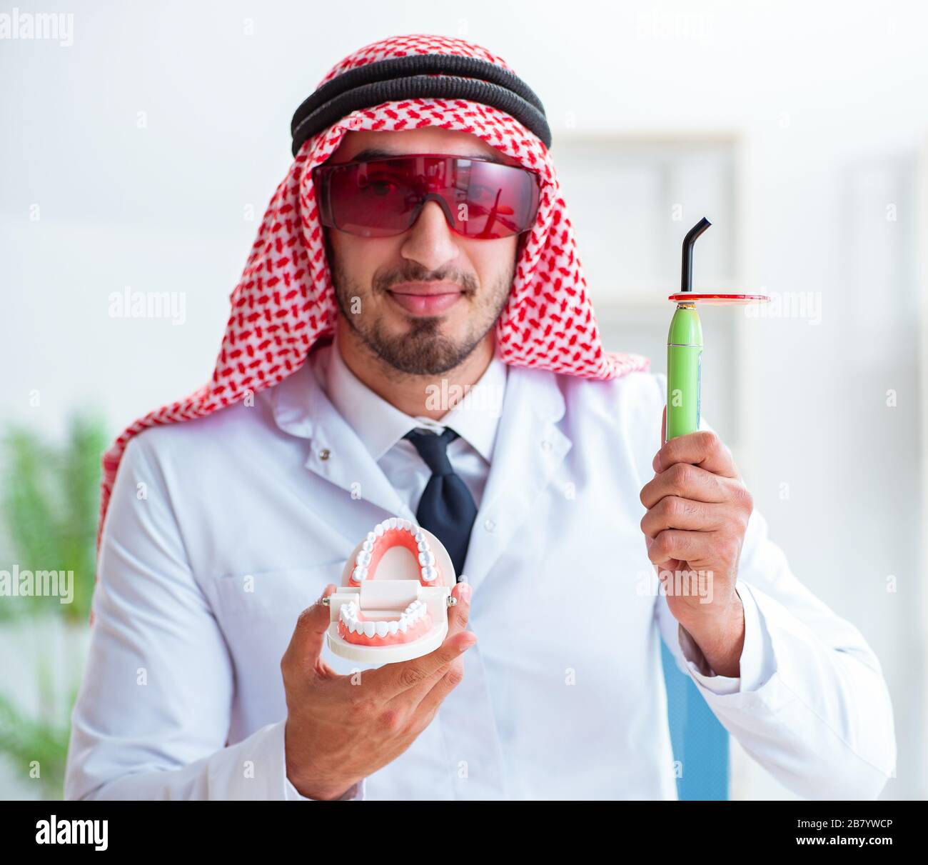 The arab dentist working on new teeth implant Stock Photo - Alamy