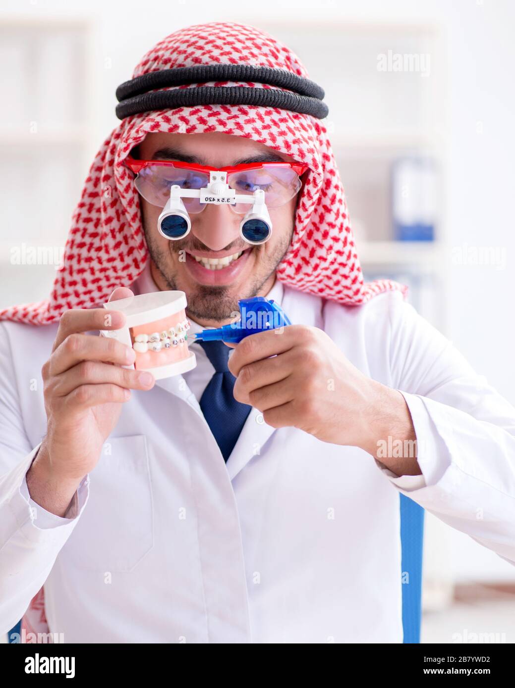 The arab dentist working on new teeth implant Stock Photo - Alamy