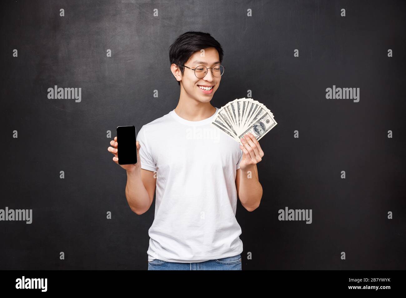 Technology, money and prizes concept. Pleased smiling happy rich asian ...