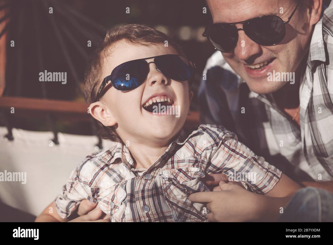 Father and son playing in the park at the day time. People having fun ...