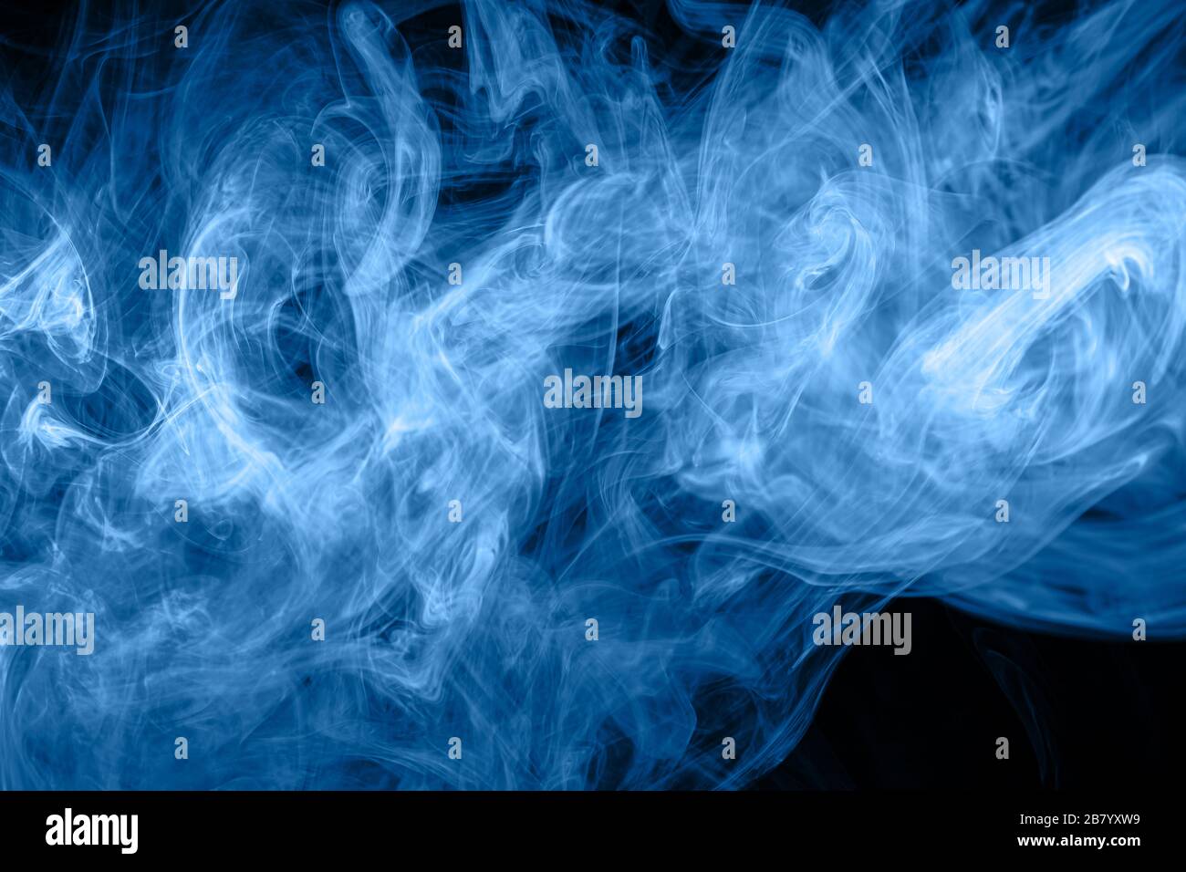 Colorful blue smoke on a black isolated background. Background from the ...
