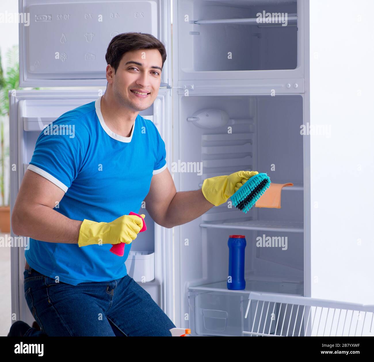 The man cleaning fridge in hygiene concept Stock Photo - Alamy