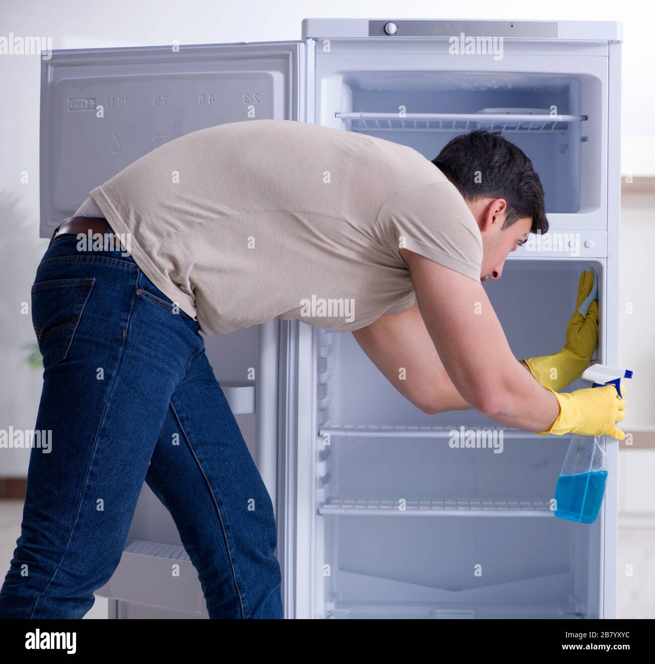 The man cleaning fridge in hygiene concept Stock Photo - Alamy