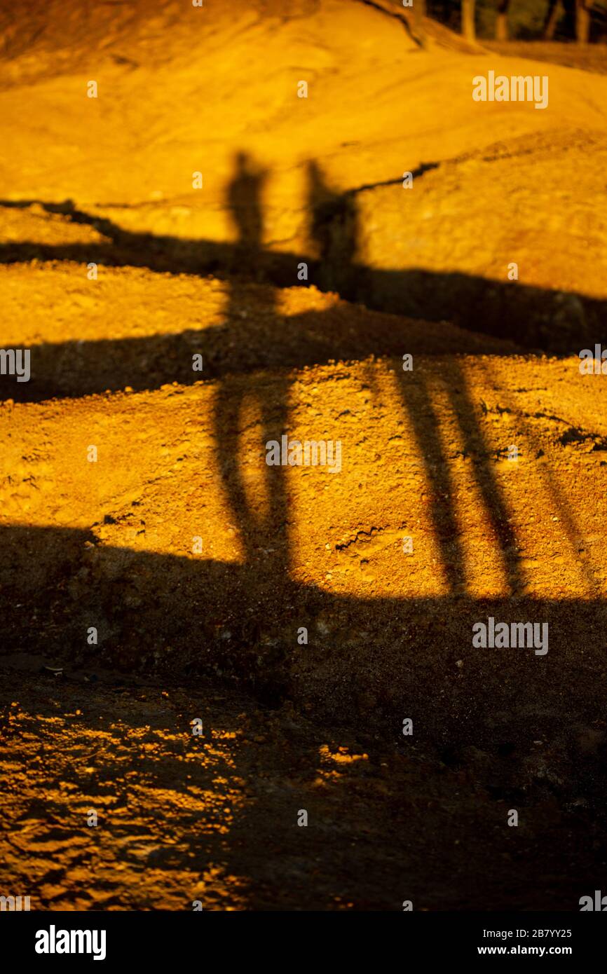shadow of couple of people walking in the desert Stock Photo - Alamy