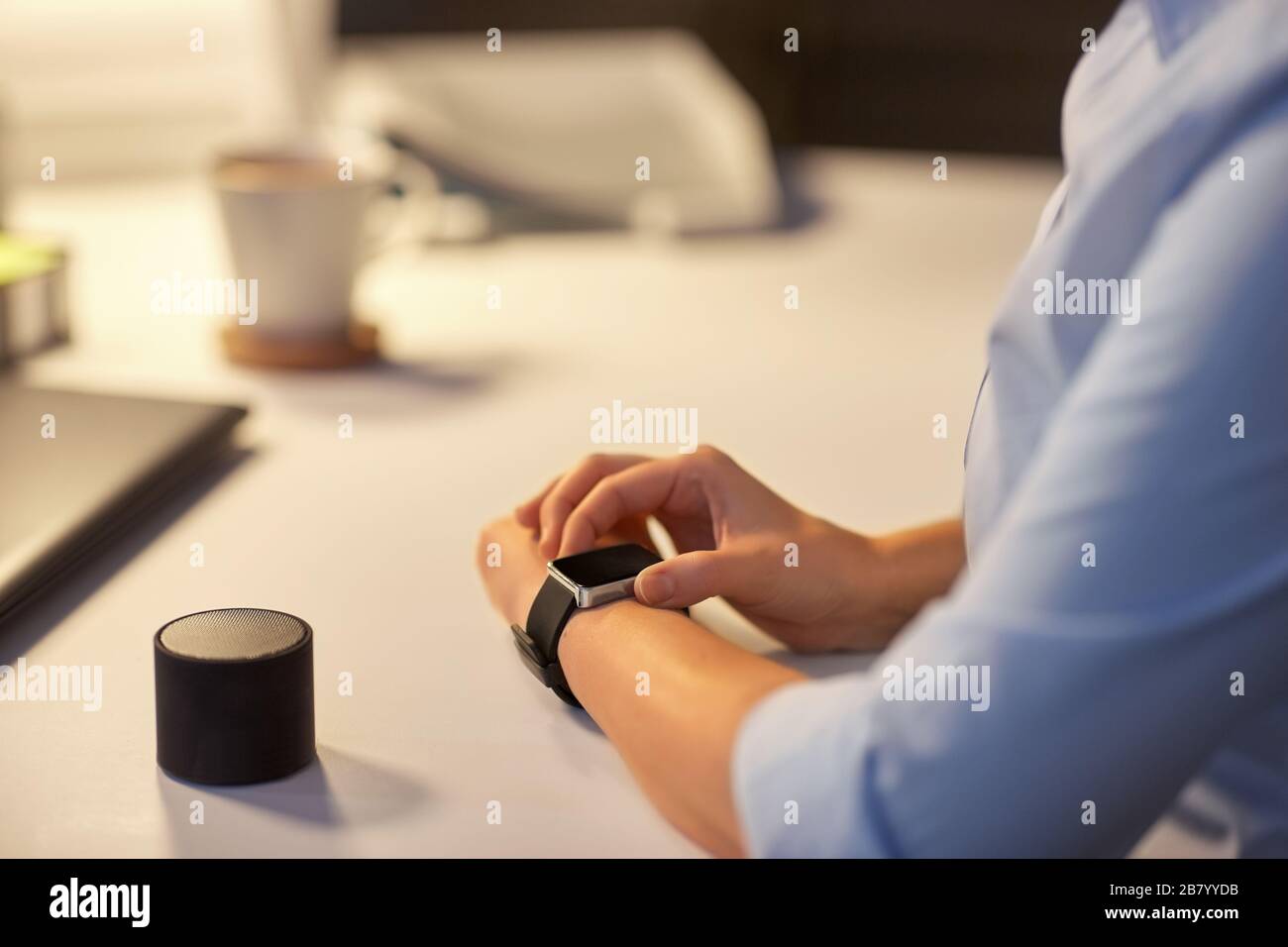 woman with smart watch and speaker at night office Stock Photo - Alamy