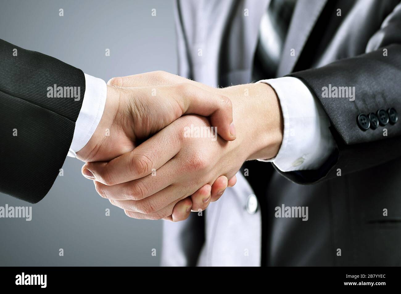 Photo of handshake of business partners after signing promising ...