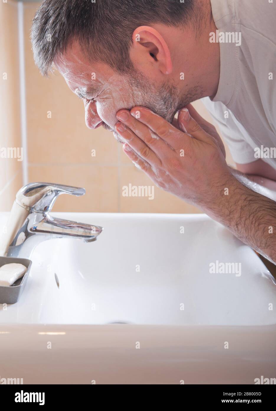 Man Washing Face In Bathroom Sink Stock Photo - Alamy