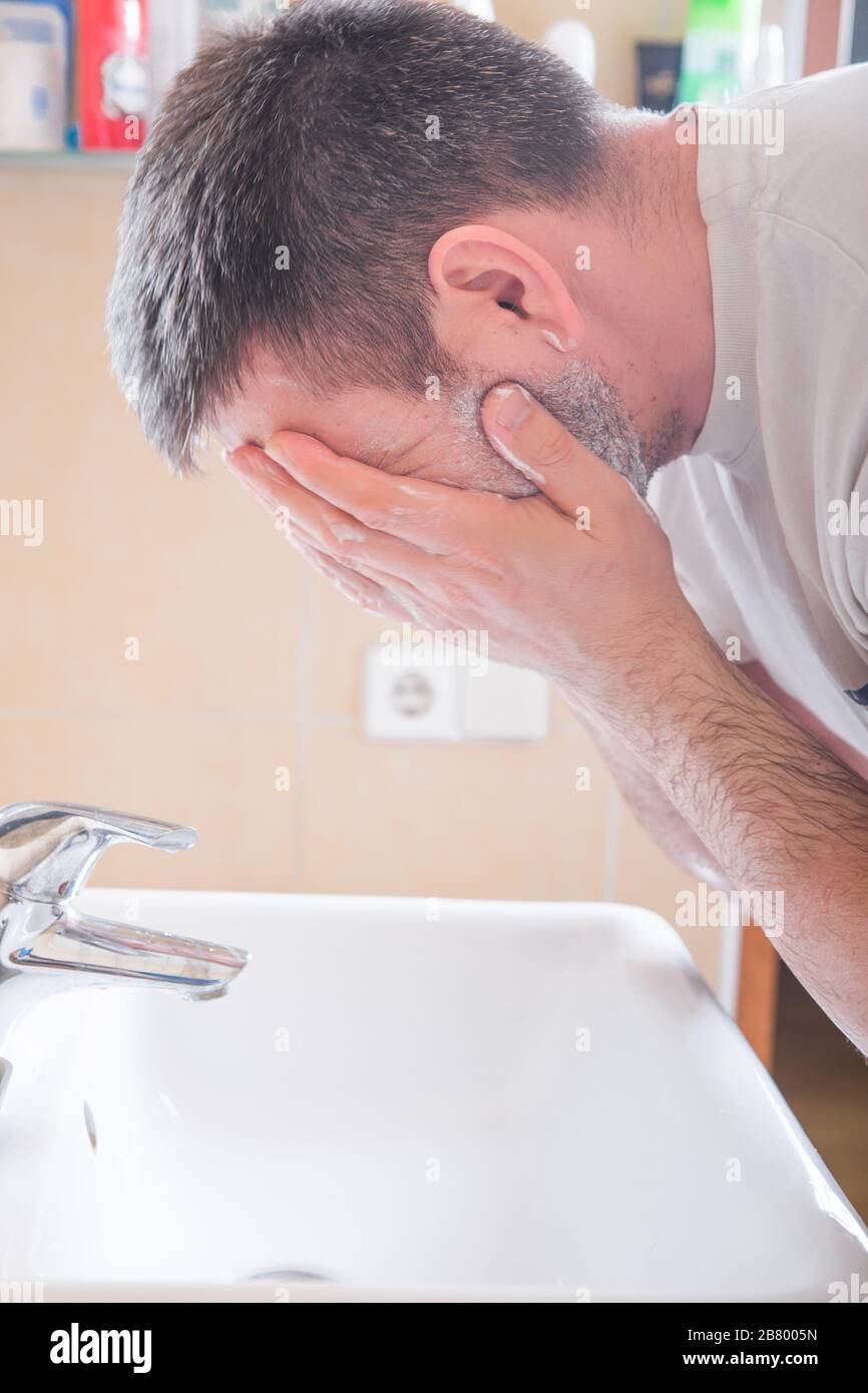 Man Washing Face In Bathroom Sink Stock Photo - Alamy