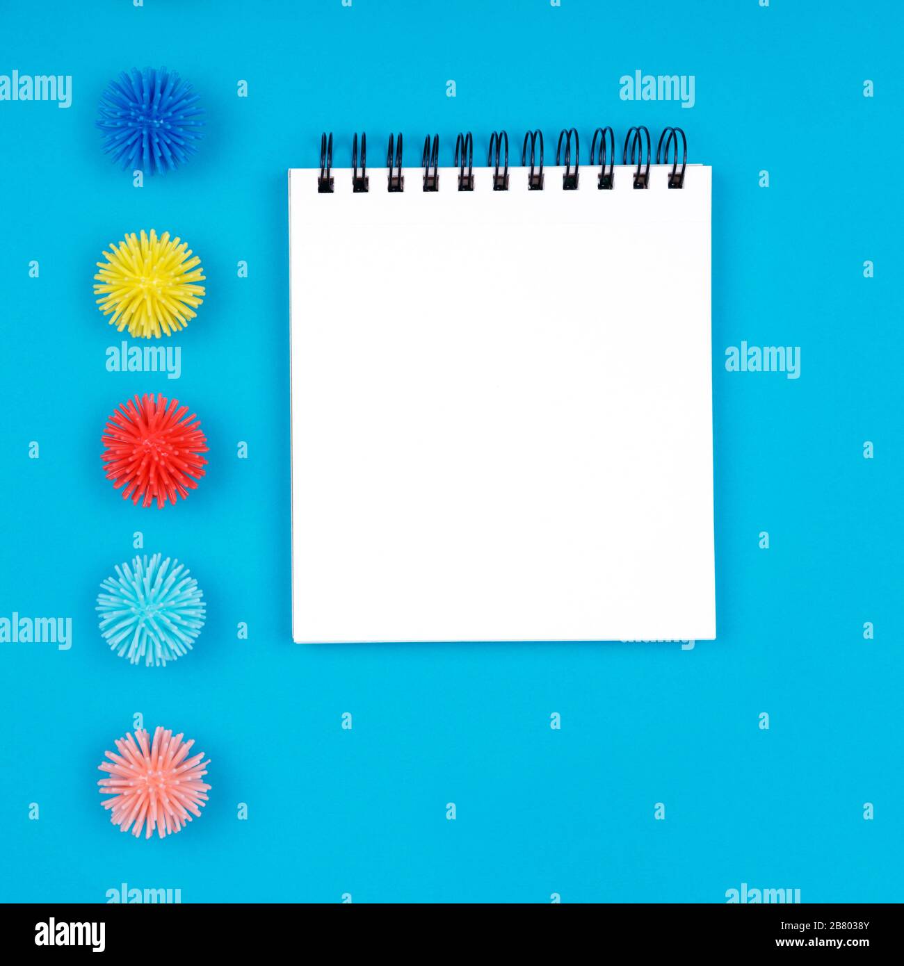 Paper notebook with plastic balls viruses on the blue background ...