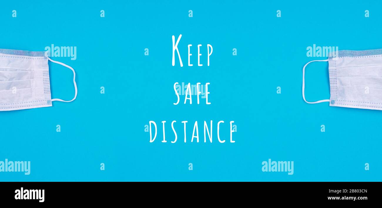 Two medicine masks on the blue background with Keep Safe Distance ...