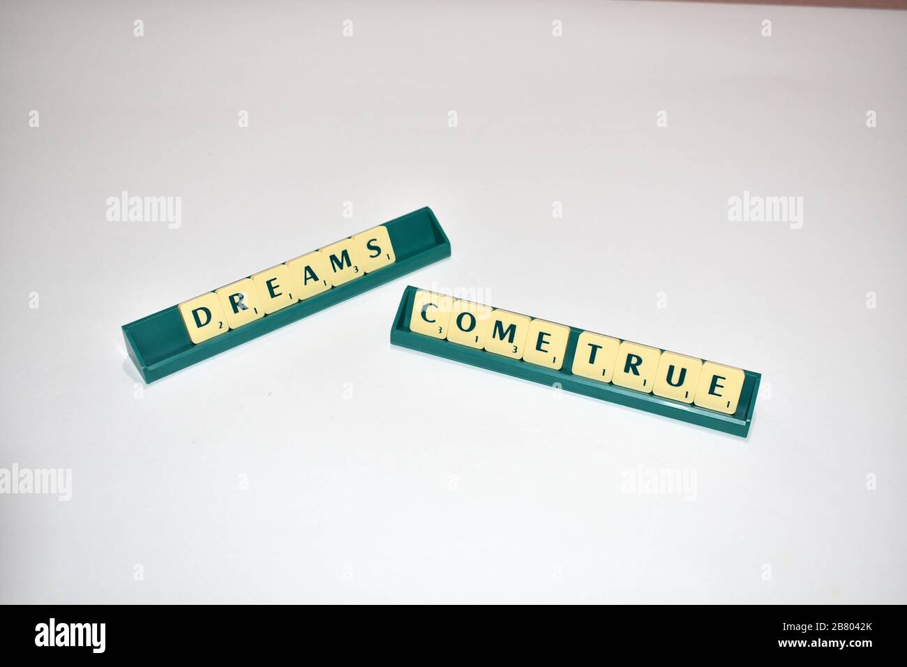 Scrabble tiles spell out Dreams Come True. Motivational quote Scrabble ...