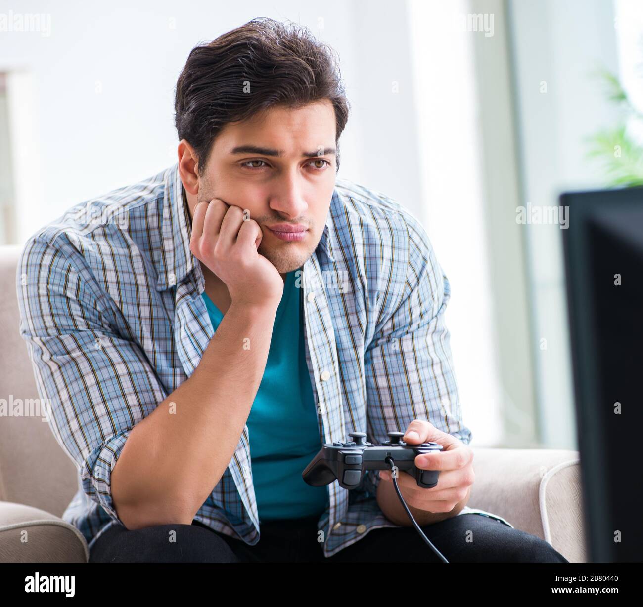 The man playing computer game at home Stock Photo - Alamy