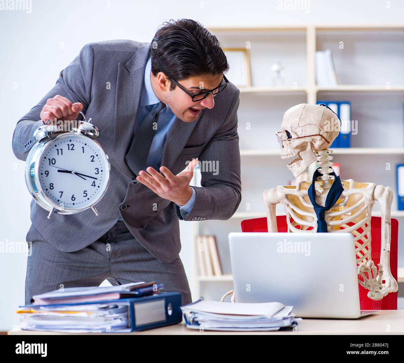 The angry boss yelling at his skeleton employee Stock Photo - Alamy