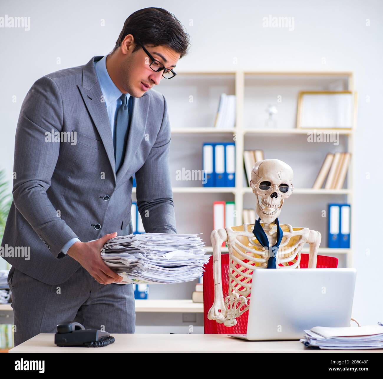 The angry boss yelling at his skeleton employee Stock Photo - Alamy