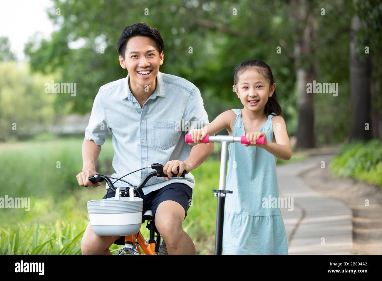 Happy Chinese father and daughter playing in park Stock Photo - Alamy