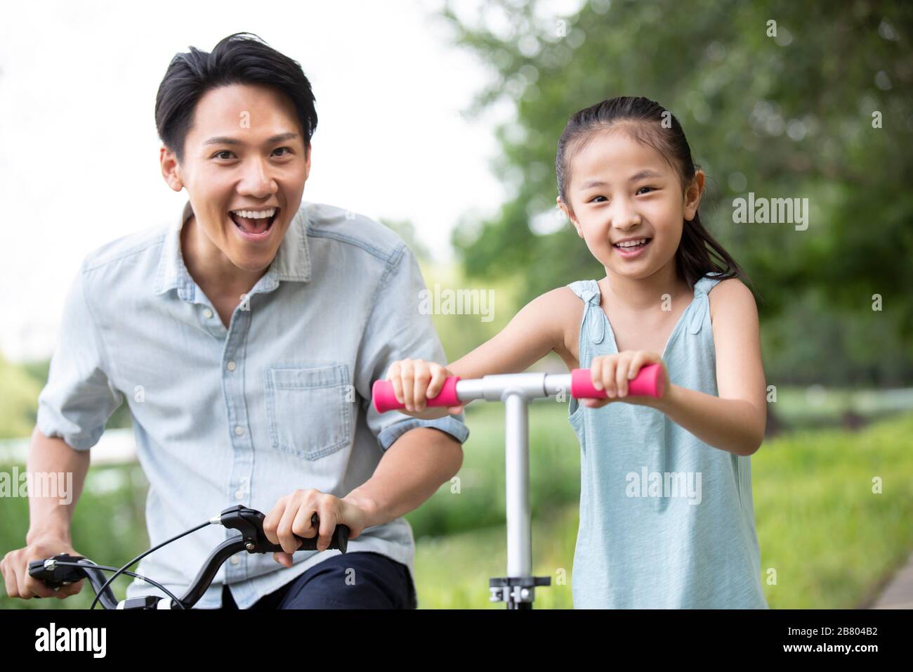 Happy Chinese father and daughter playing in park Stock Photo - Alamy