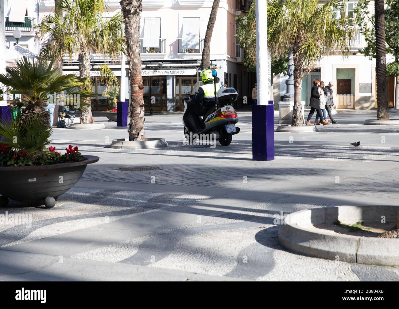 Police officer on a moped in the town centre of Cadiz, Spain Stock ...
