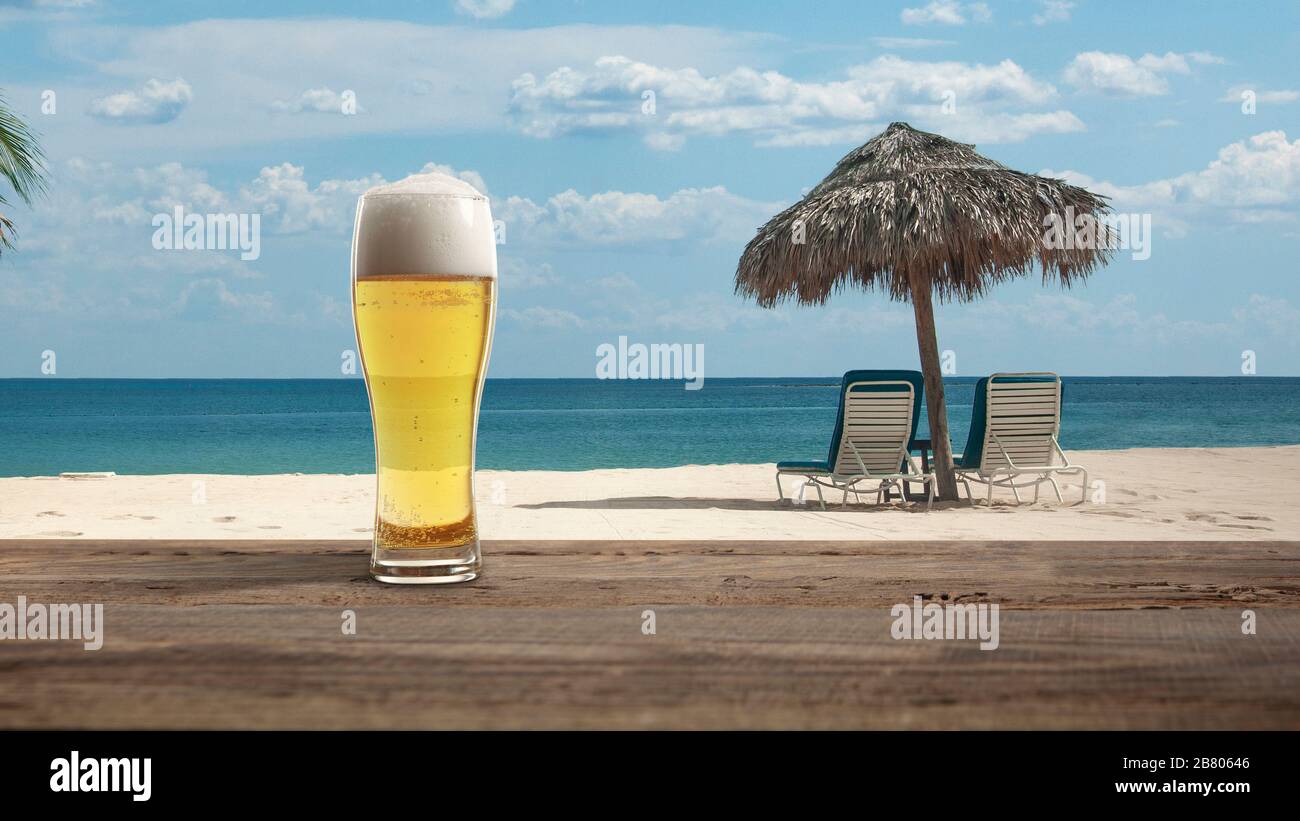 Weekend. Glass with cold beer in sunshine with sea or ocean beach with ...