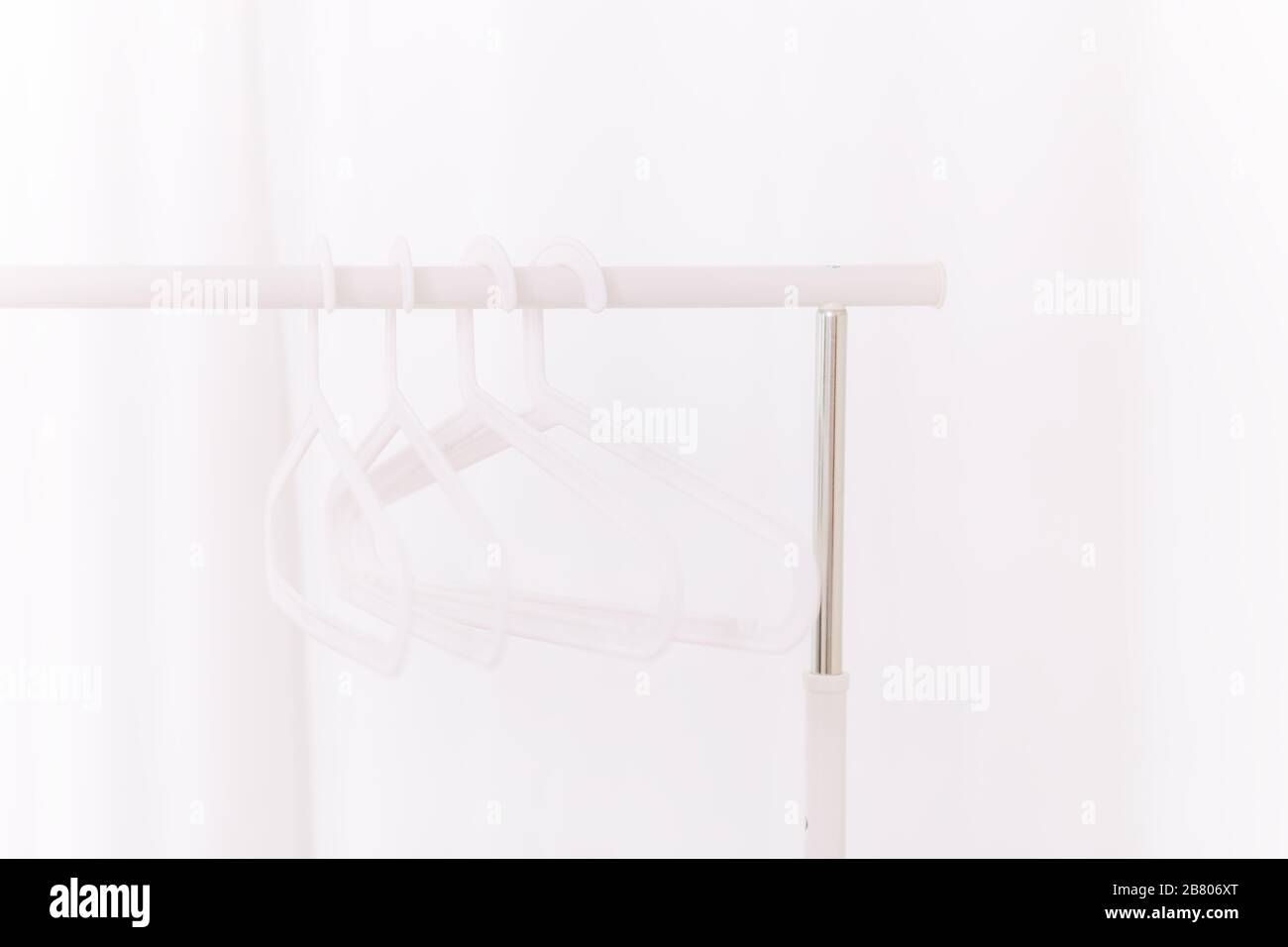 Stylish white hangers Stock Photo - Alamy