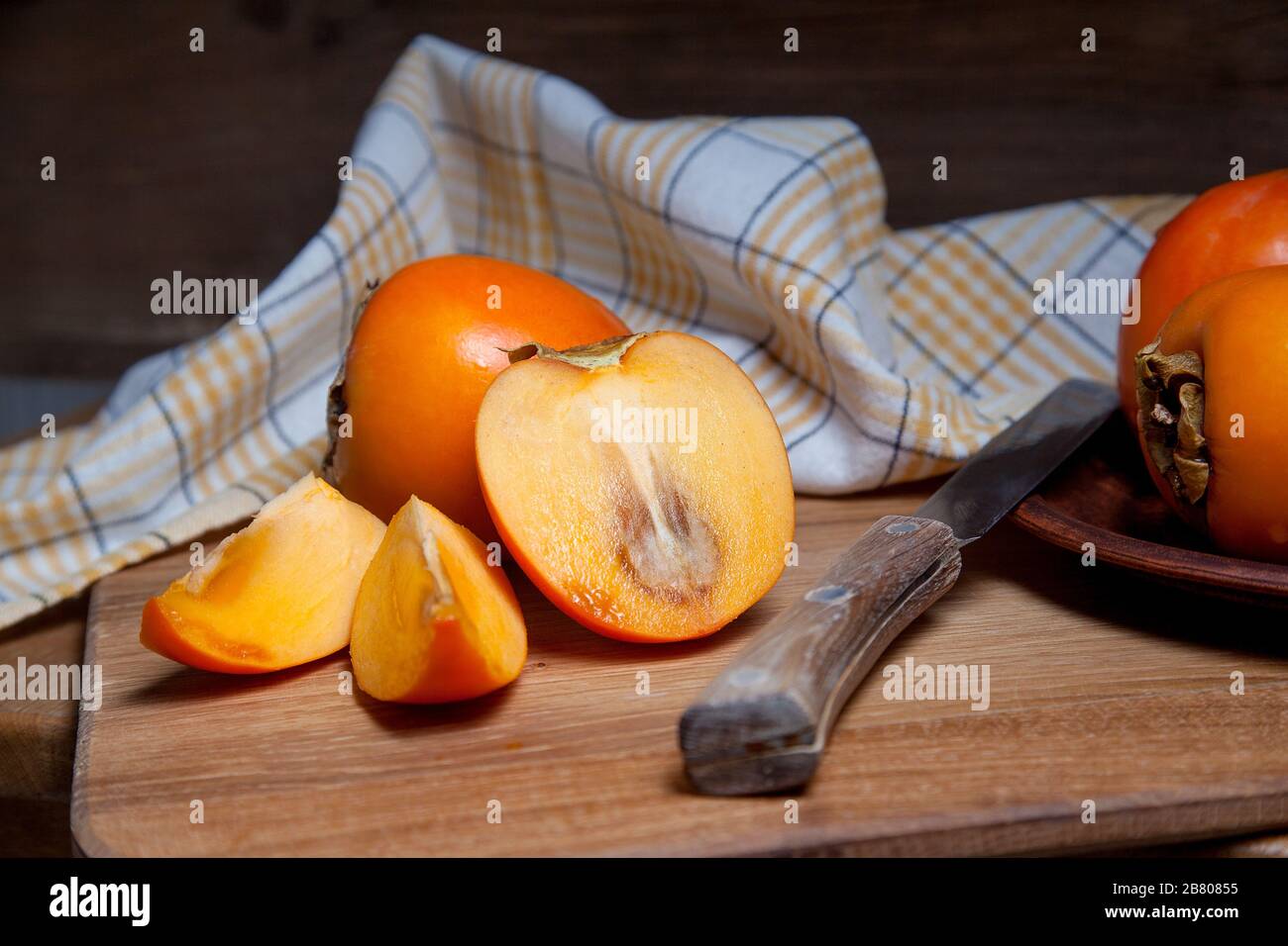 Composition of ripe delicious whole persimmon fruits, half and sliced ...