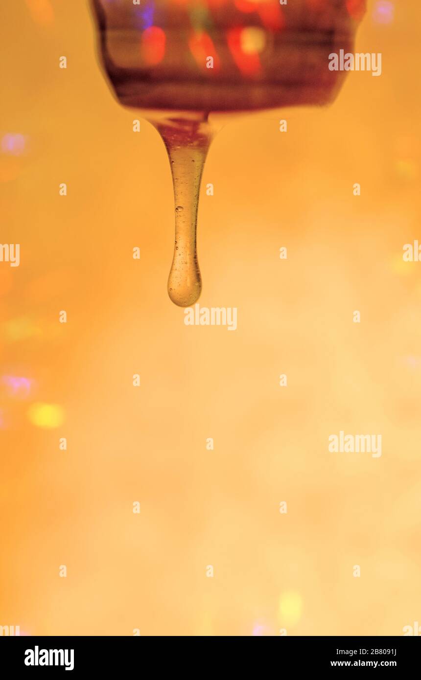 Melted caramel dripping. Pouring stream of caramel sauce. Hot sweet ...