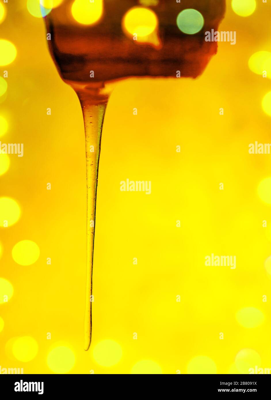 Honey flow dropping. Sweet amber flower honey flows Stock Photo - Alamy