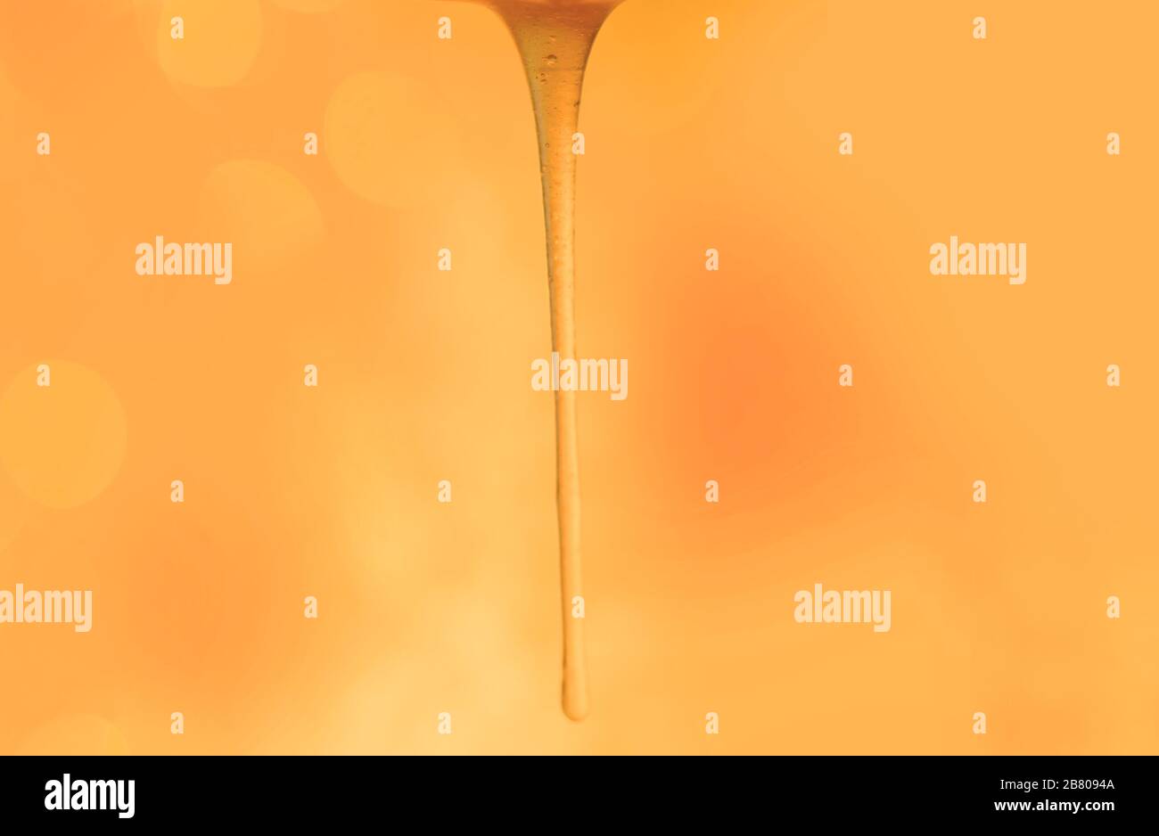 Melted caramel dripping. Pouring stream of caramel sauce. Hot sweet ...