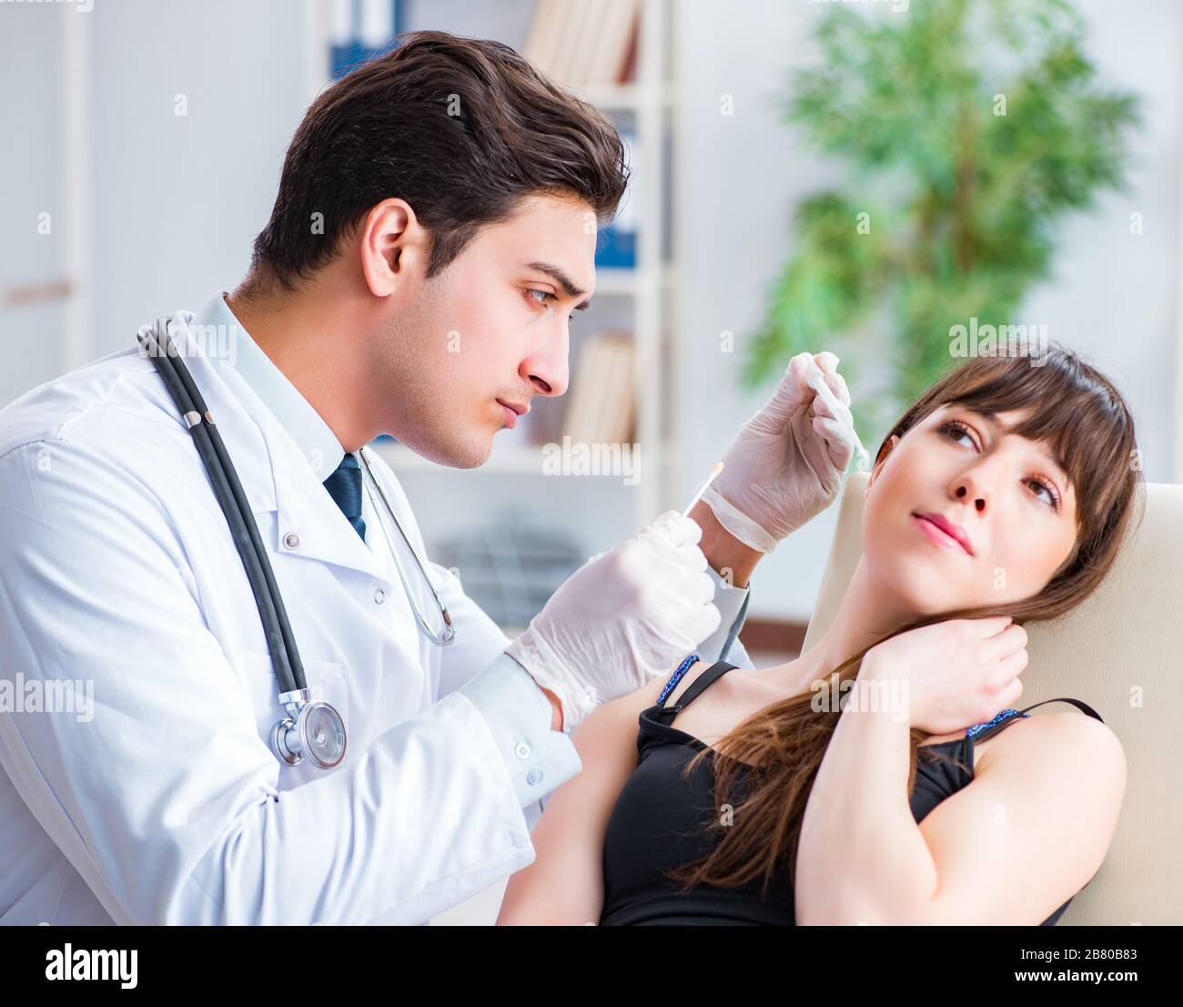 The doctor checking patients ear during medical examination Stock Photo ...
