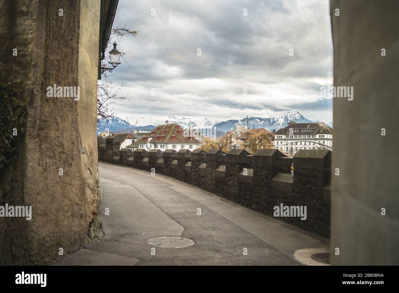 Concrete path behind a building with a view of a cloudy skyline Stock ...