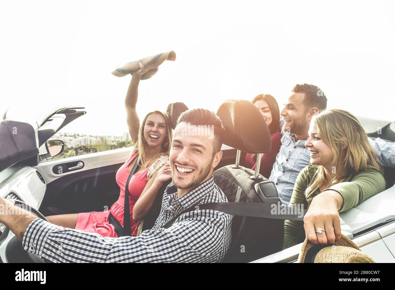 Happy friends having fun in convertible car on summer vacation - Young ...