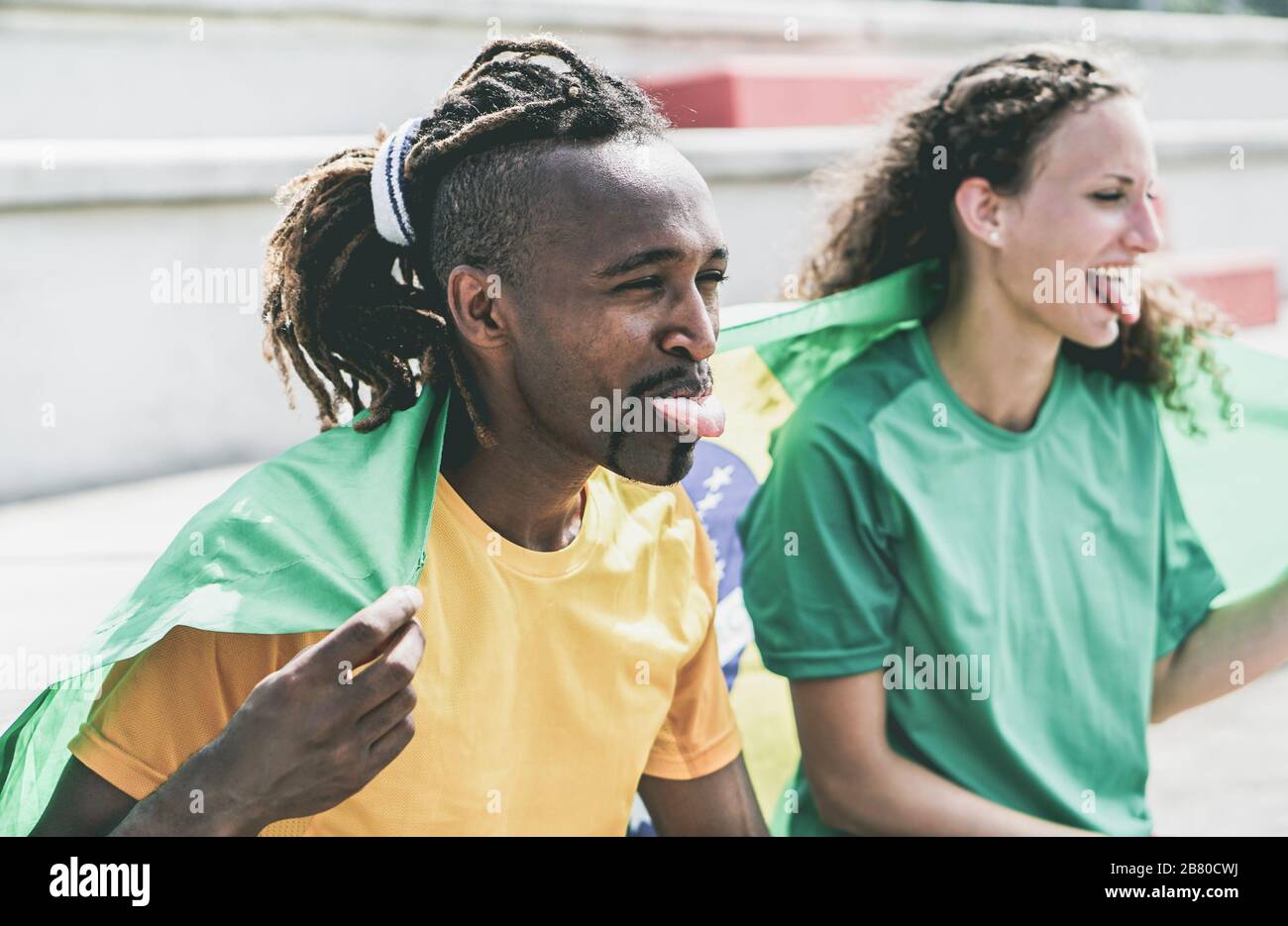 Two brazilian sport fans celebrating their country - Multiracial ...