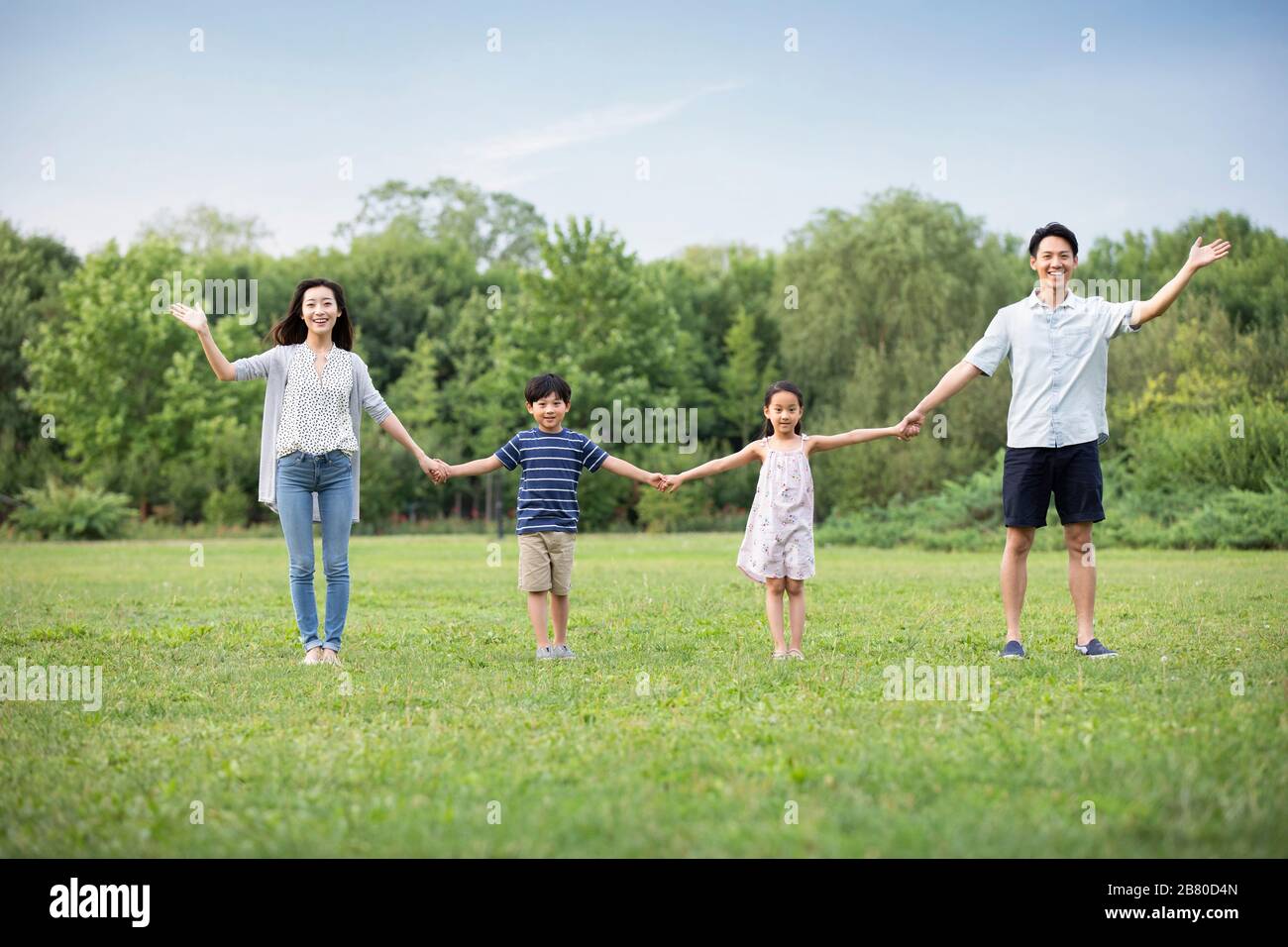 Family with two children waving to camera hi-res stock photography and ...