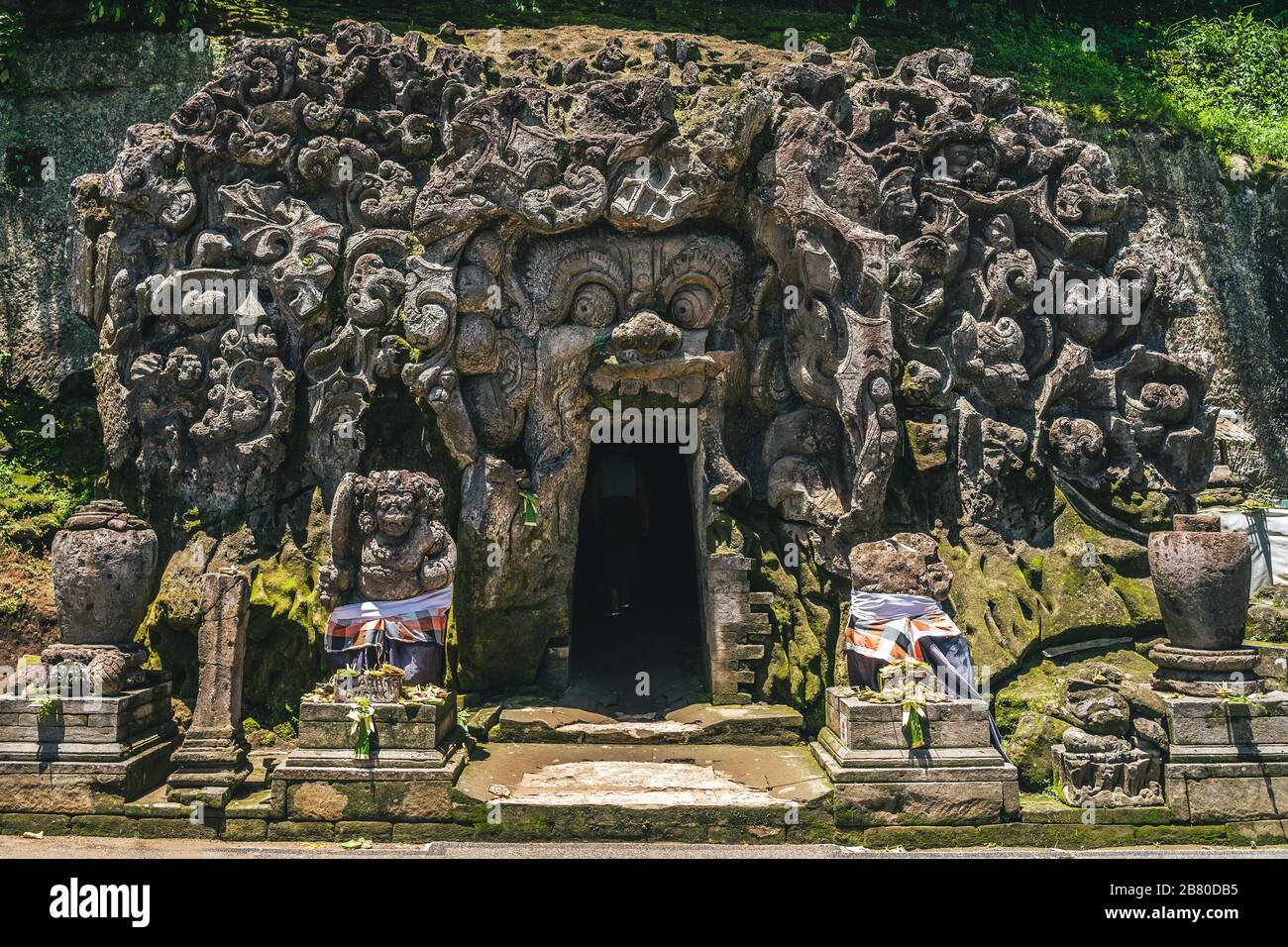 Entrance of Goa Gajah Elephant Cave with carvings of faces in Bali ...