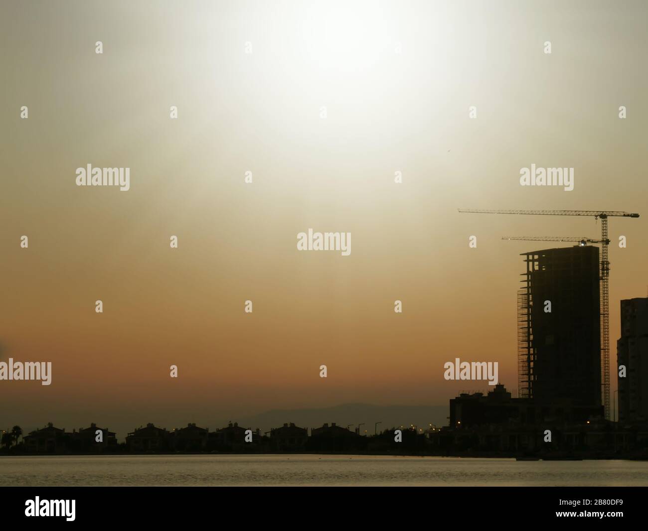 Construction Tower and sky-scraper building and crane against colorful ...